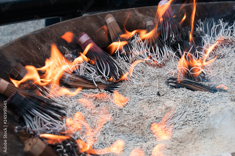 線香のお焚き上げ Senko, incense sticks, on fire at Japanese temple for praying ...