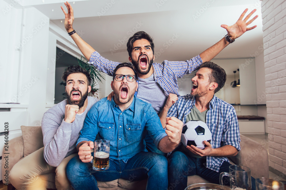 Men watching sport on tv together at home screaming cheerful. Group of ...