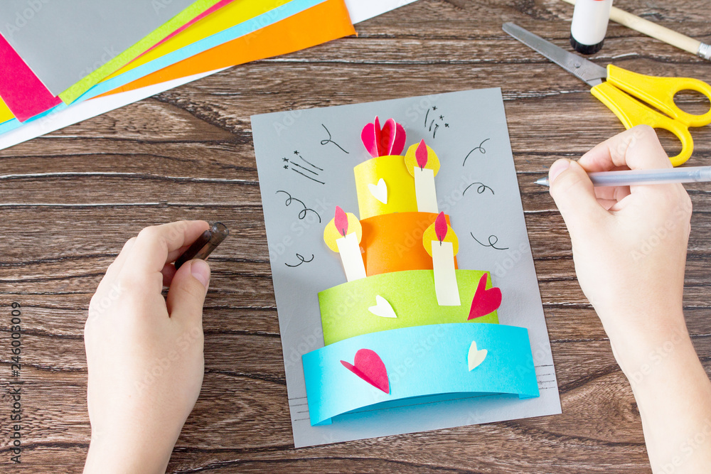 The child draws details Greeting card with birthday cake congratulation ...