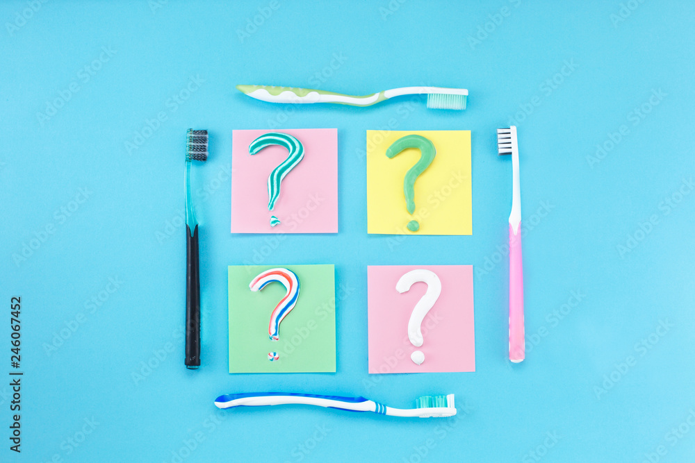 Symbol of question mark from toothpaste and toothbrush on blue ...
