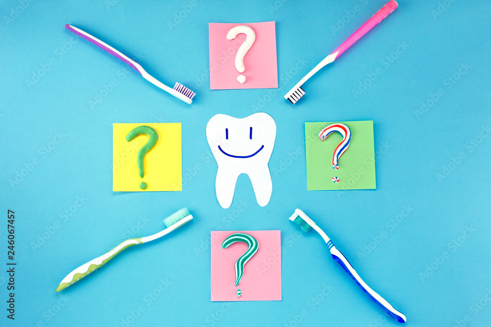Symbol of question mark from toothpaste and toothbrush on blue ...