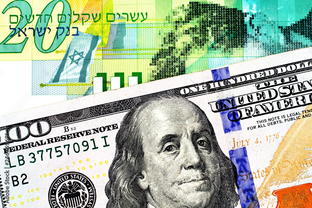 A close up image of a twenty Israeli shekel note with an American one ...