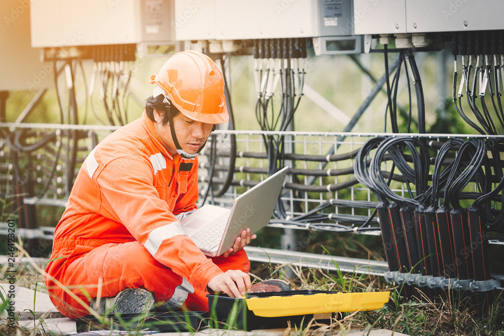 engineer or electrician holding laptop for inspect and checking string ...