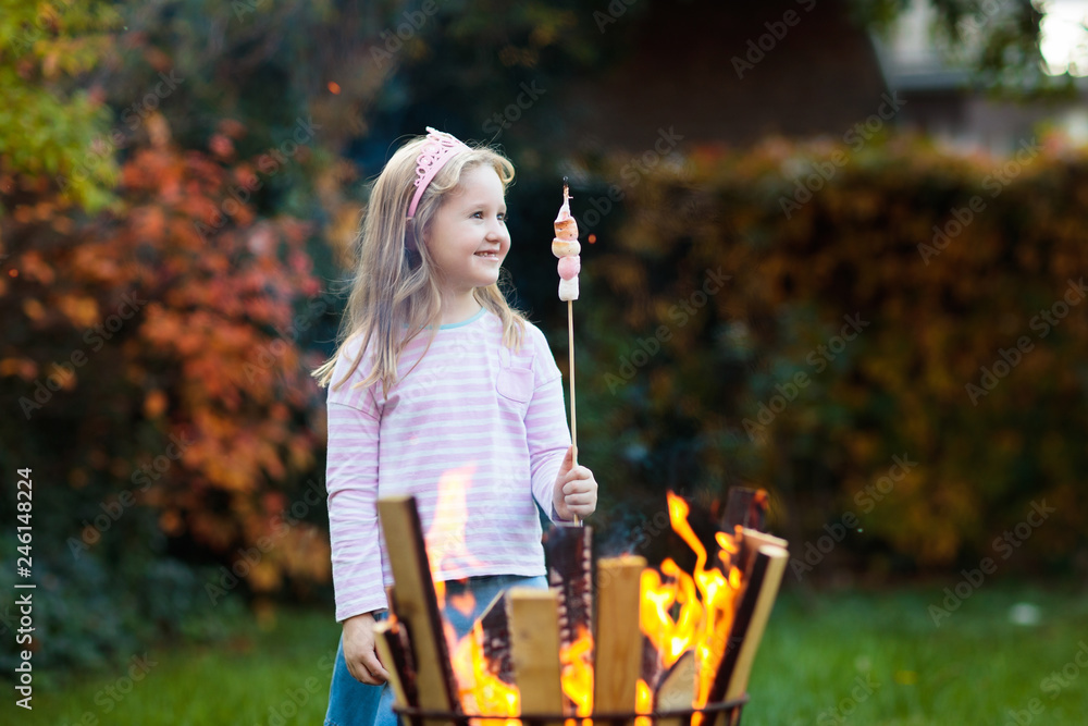 Child with smores at fire. Kids roast marshmallow. Stock Photo | Adobe ...