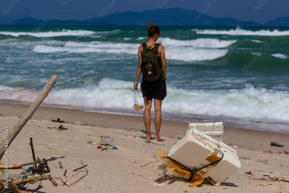 Beach pollution, plastic and waste from ocean on the beach. tourist on ...