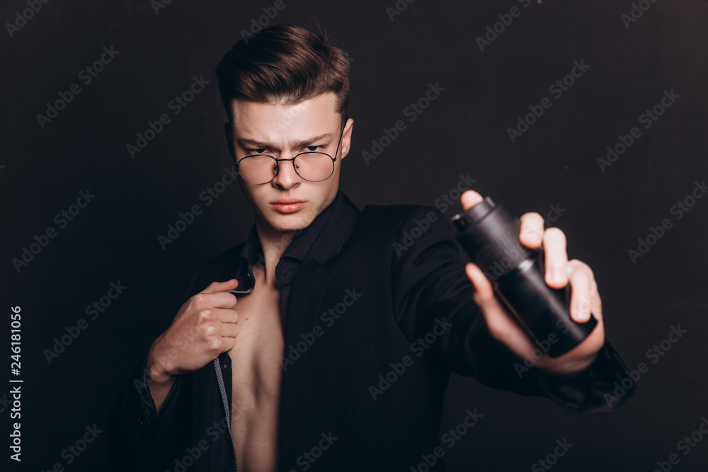 Handsome shirtless man putting deodorant. image of young man using ...