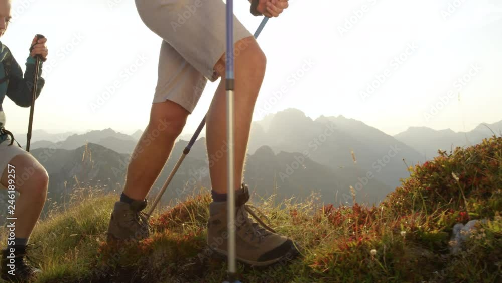 LENS FLARE, SLOW MOTION, CLOSE UP: Unrecognizable hikers wearing ...