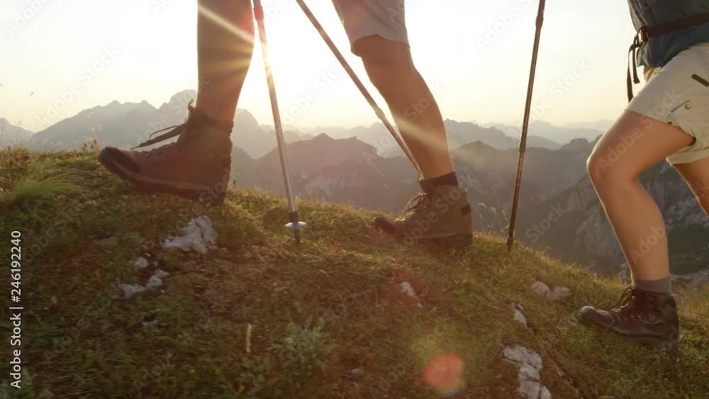 SLOW MOTION, CLOSE UP, LENS FLARE: Tourist couple wearing hiking boots ...
