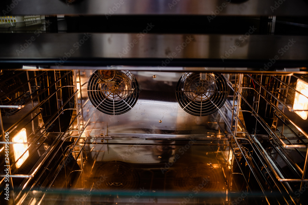 Modern kitchen, inside of the oven, open. New electric oven in kitchen ...