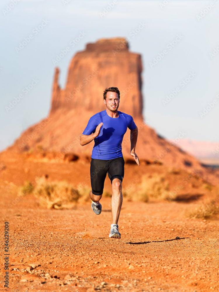 Runner. Running man sprinting in Monument Valley. Athlete runner cross ...