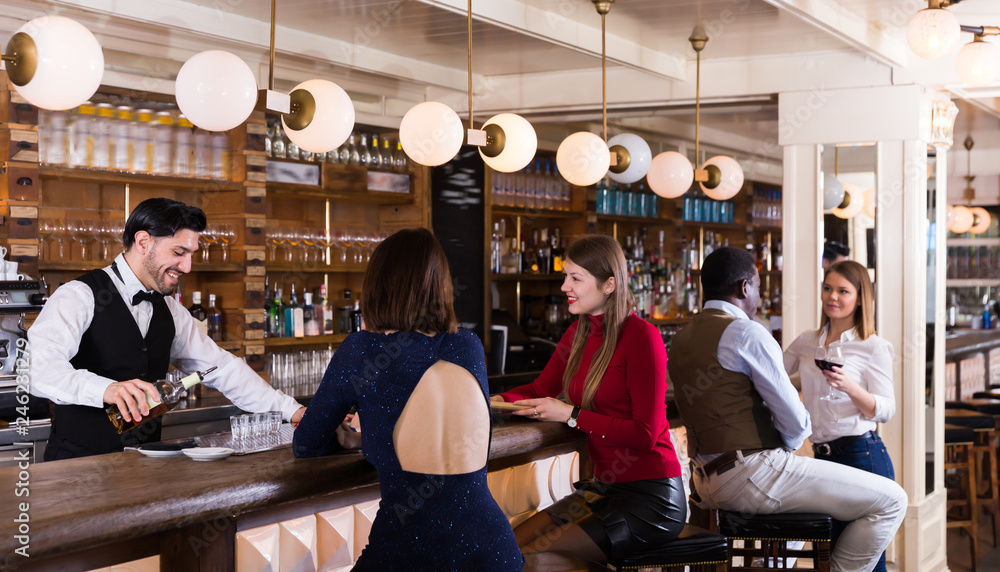 Laughing people are relaxing near bar counter Stock Photo | Adobe Stock