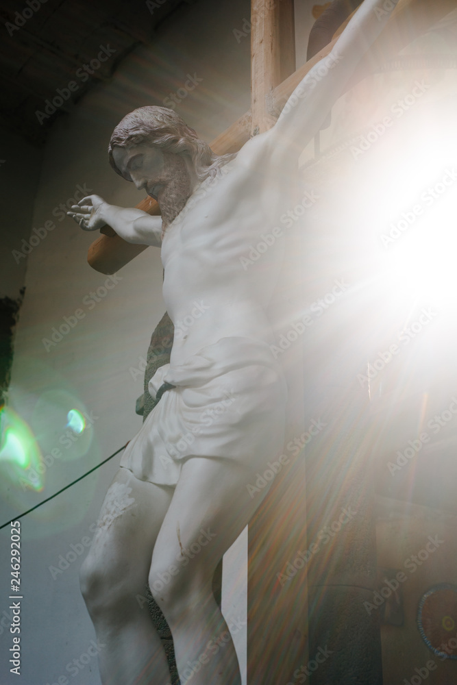 Jesus statue in Catholic cathedral. Sun rays around Stock Photo | Adobe ...