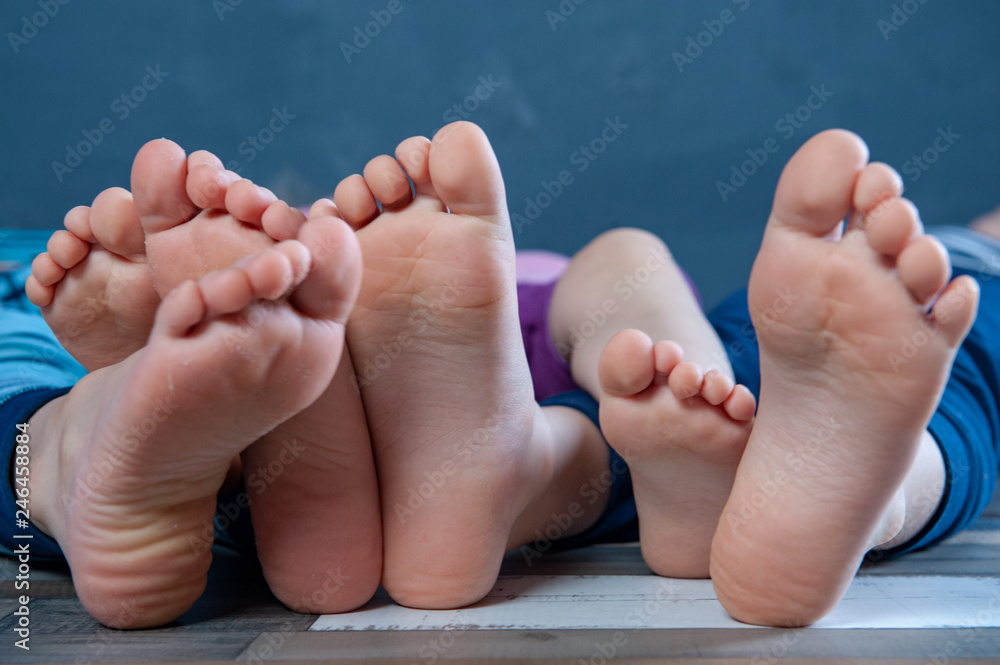 Three children are sitting on floor in room and are going to do ...