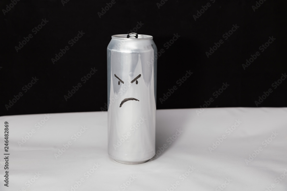 The concept of grumpy man. Angry emoticon on aluminium can, Emoji with ...