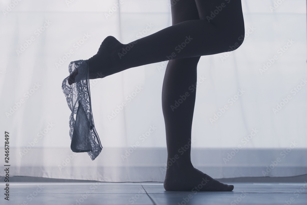 Bottom view of silhouette of beautiful woman with sexy legs taking off ...