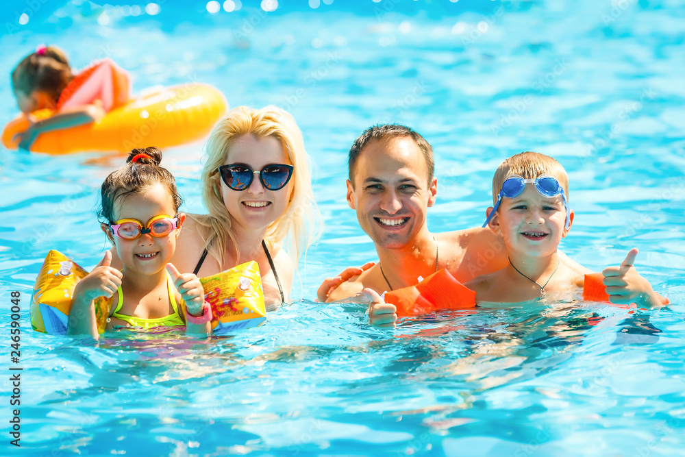 Happy family in swimming pool at water park Stock Photo | Adobe Stock