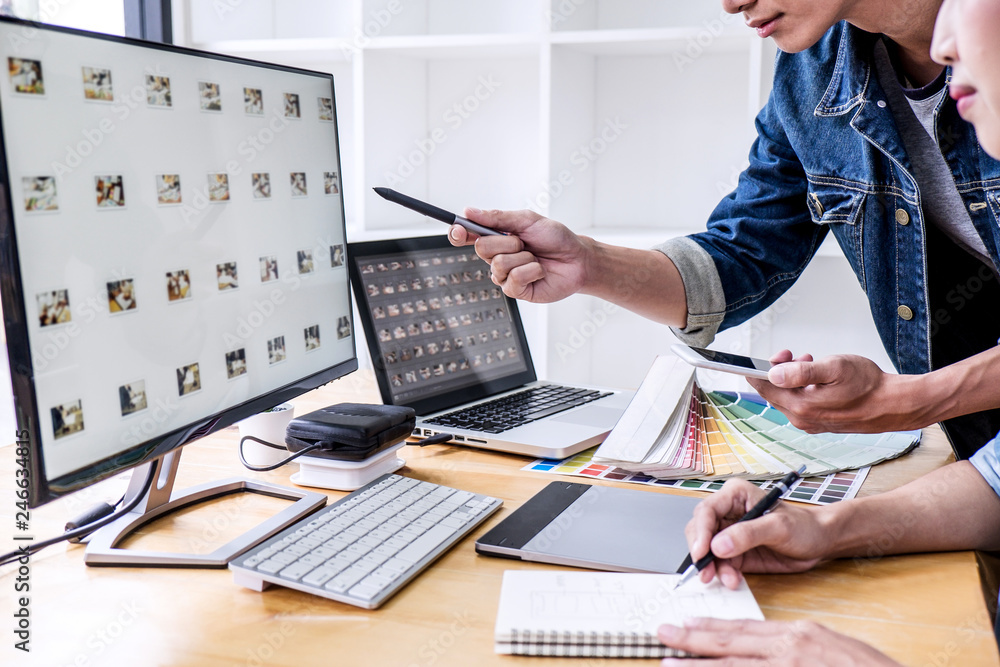 Team of young colleagues creative graphic designer working on color ...