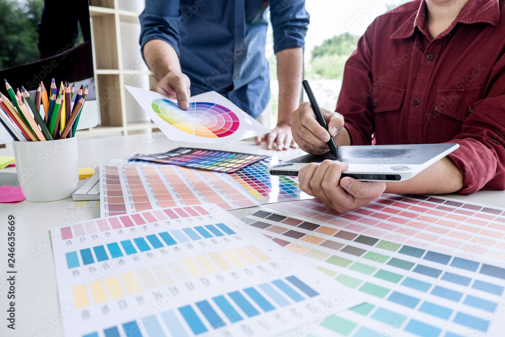 Two colleague creative graphic designer working on color selection and ...
