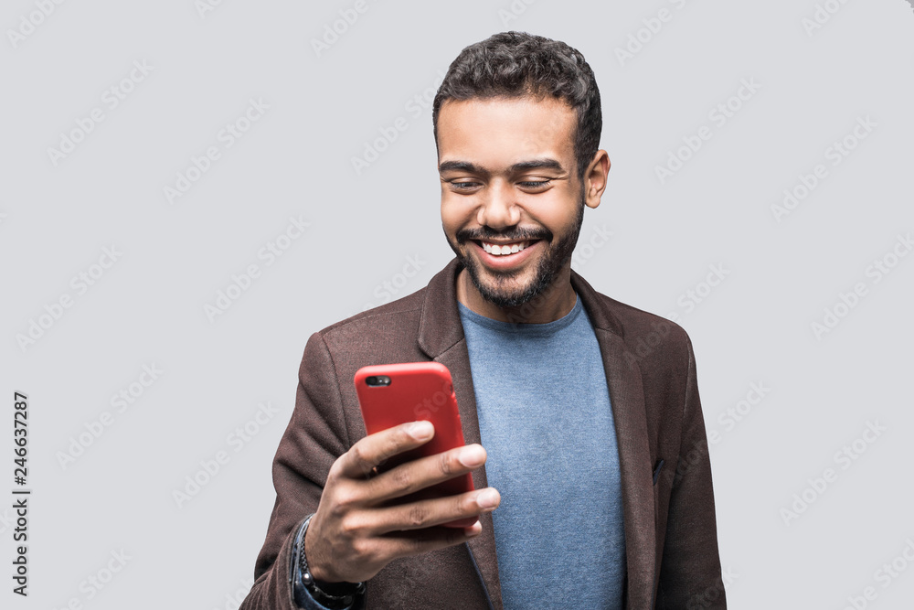 Portrait of handsome cheerful smiling young man using smartphone ...