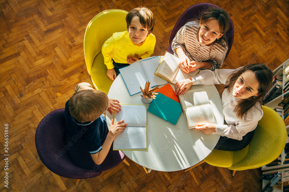 Teacher Reading At Table