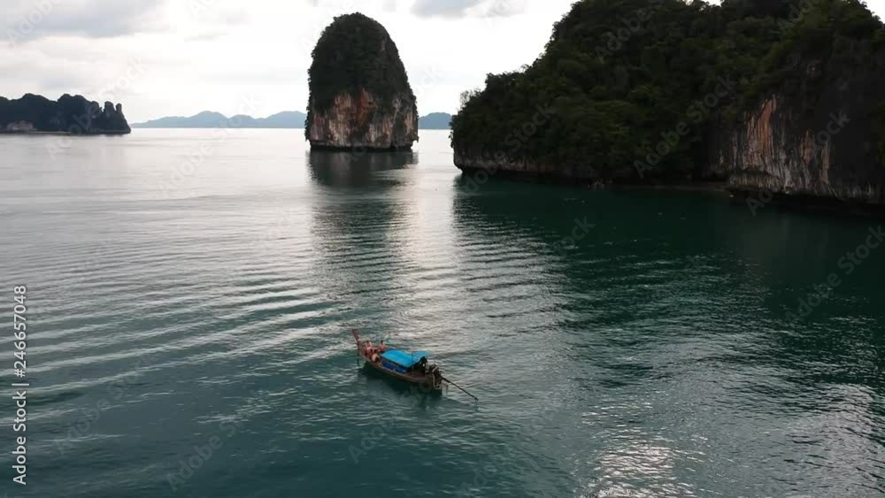 Drone footage of longtail boat navigating around islands of Thailand ...