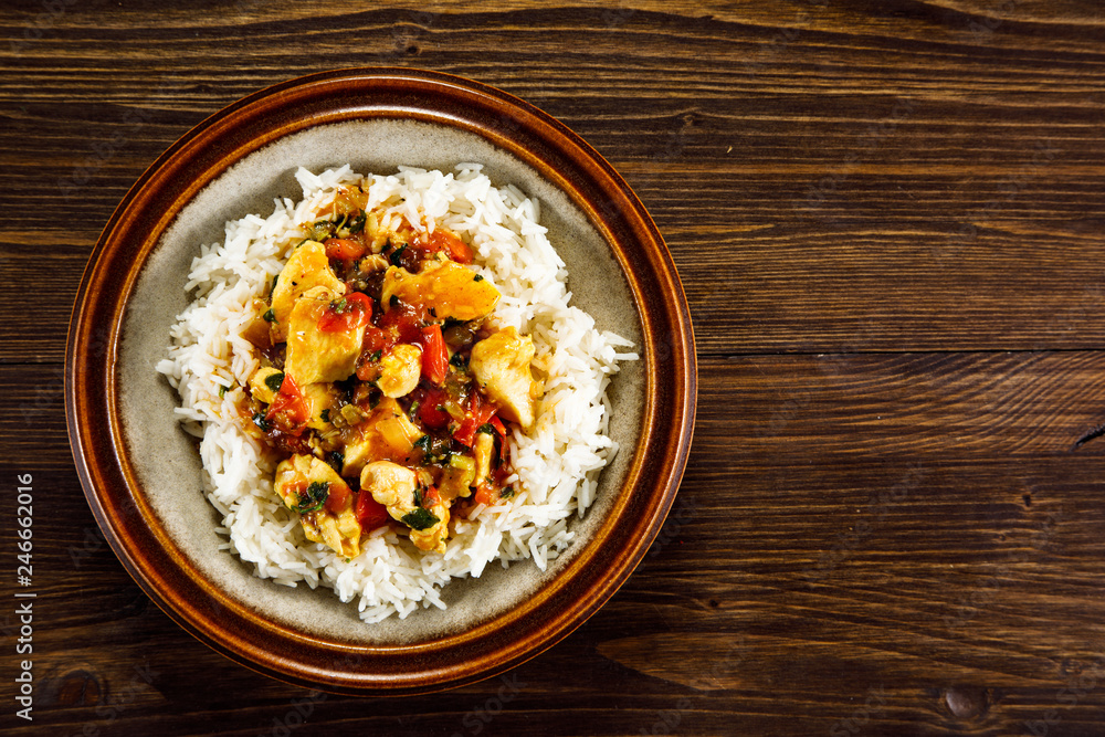 Grilled meat, white rice and vegetables on wooden table Stock Photo ...