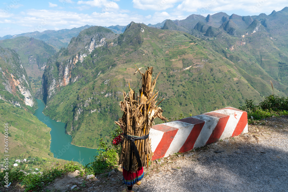 Ha Giang mountain view at Ma Pi Leng pass with children carry wood on ...