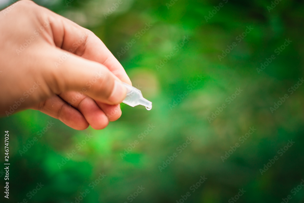 Man holding and droping eye drop Stock Photo | Adobe Stock