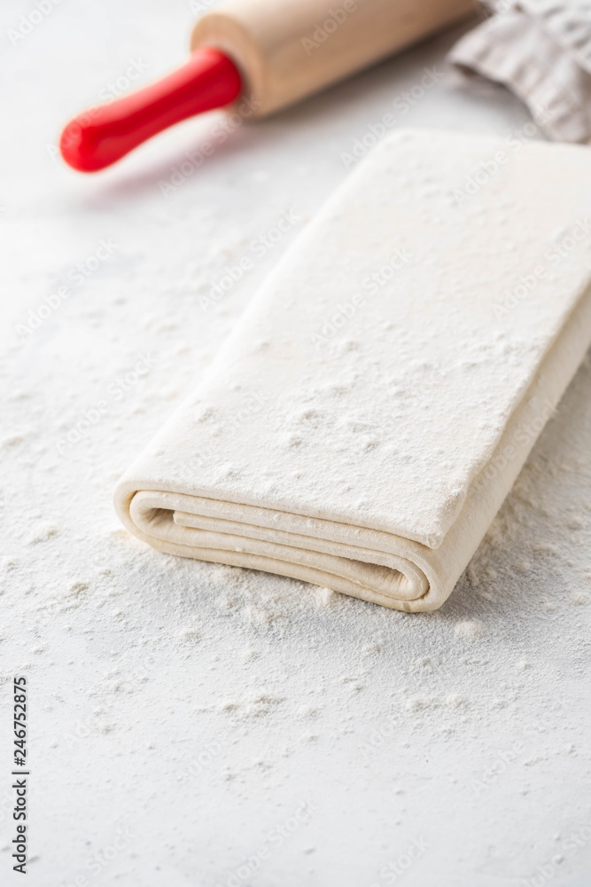 Homemade raw puff pastry on a white background. Stock Photo | Adobe Stock