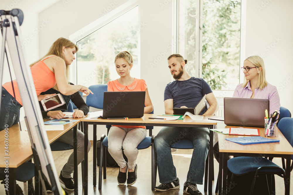 Students and teacher tutor in classroom Stock Photo | Adobe Stock