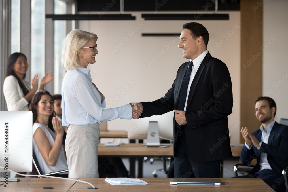 Executive ceo manager and middle aged female employee shake hands ...
