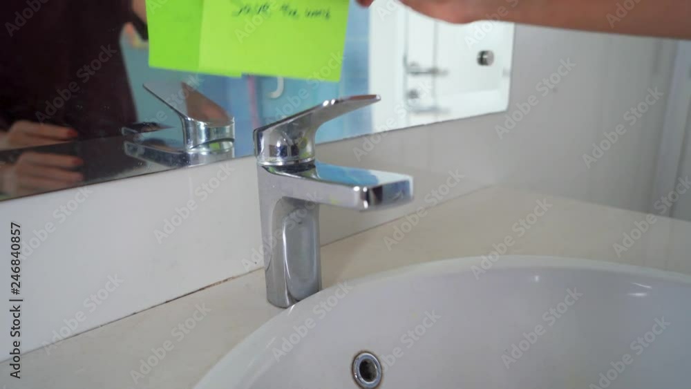 Woman hand shut the faucet, prevent from leaking the water and ...
