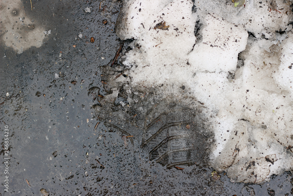 Melting snow asphalt slush water puddle flow dirty street sidewalk ...