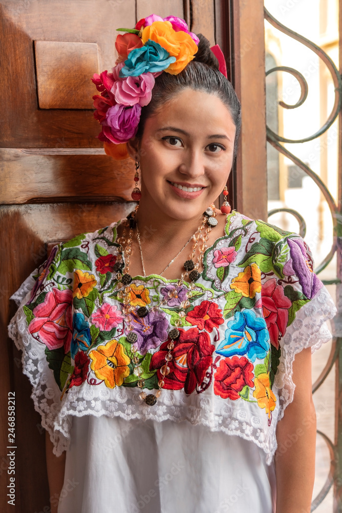 Pretty and colorful Mayan girl in Yucatan. Young smiling girl inviting ...