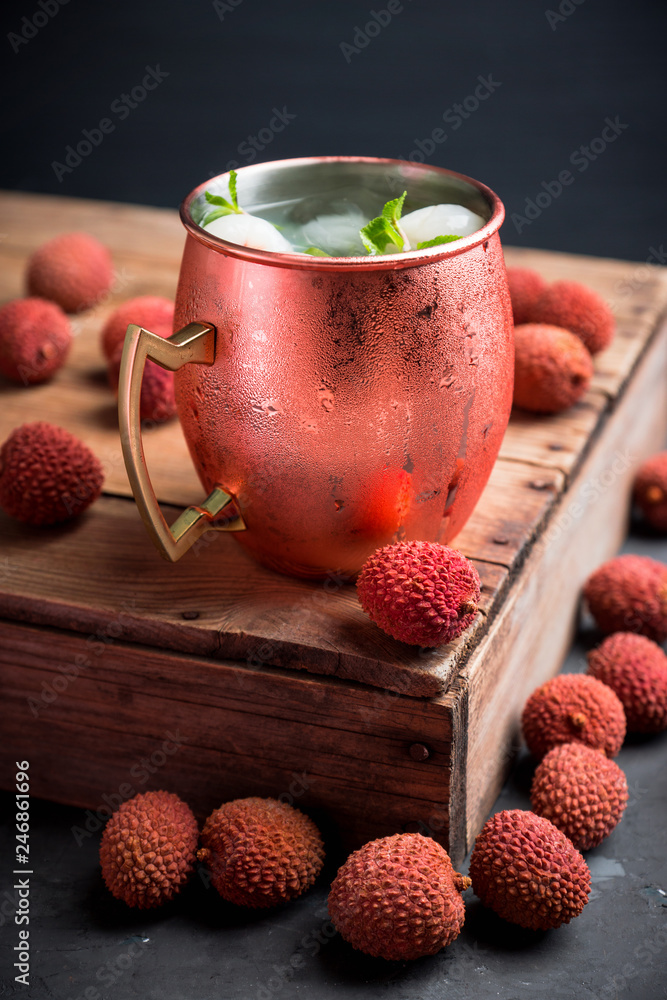 Fresh lychee moscow mule on the rustic background. Selective focus ...