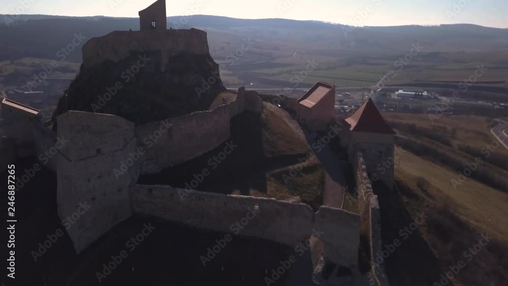 The tall stone walls of Rupea Fortress built with sharp angles for ...