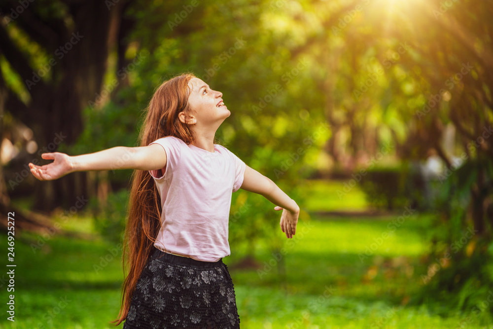 Happy cute little girl playing in the outdoor park in summer. Child ...