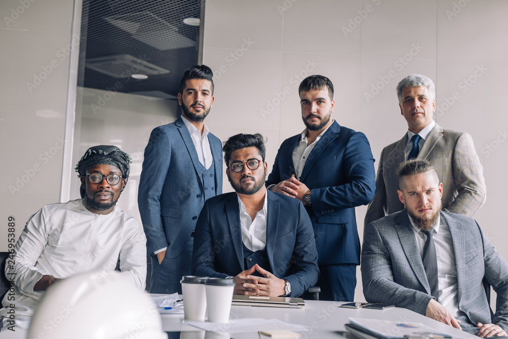 Portrait of Male business team in business suits looking at camera ...
