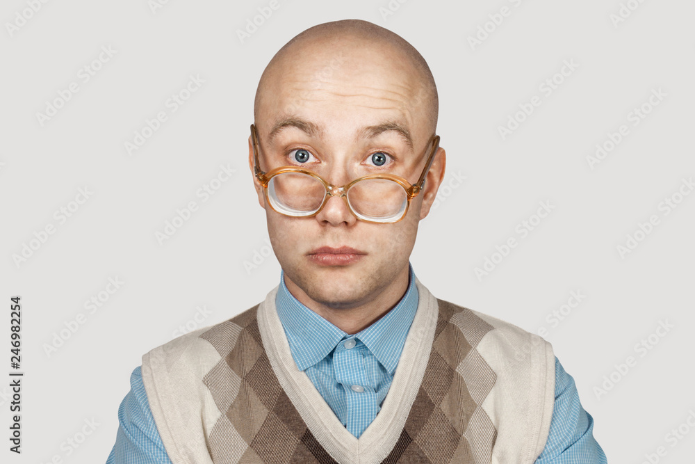 strict bald teacher with glasses looks at a student Stock Photo | Adobe ...