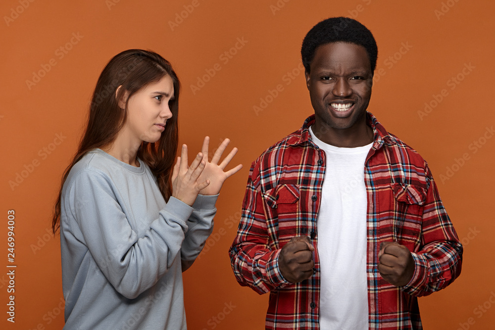 Picture of scared worried young Caucasian female tryig to calm down her ...