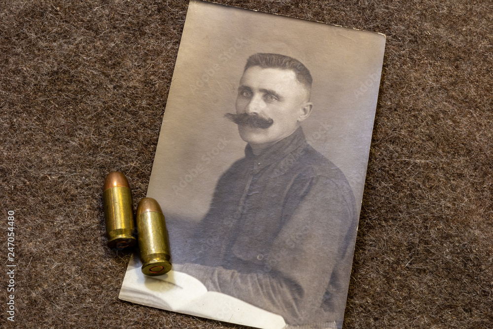Portrait of officer in period of World War I and pistol bullets on ...