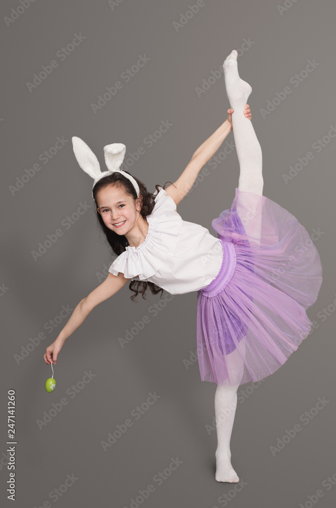 Flexible little girl doing vertical split Stock Photo | Adobe Stock