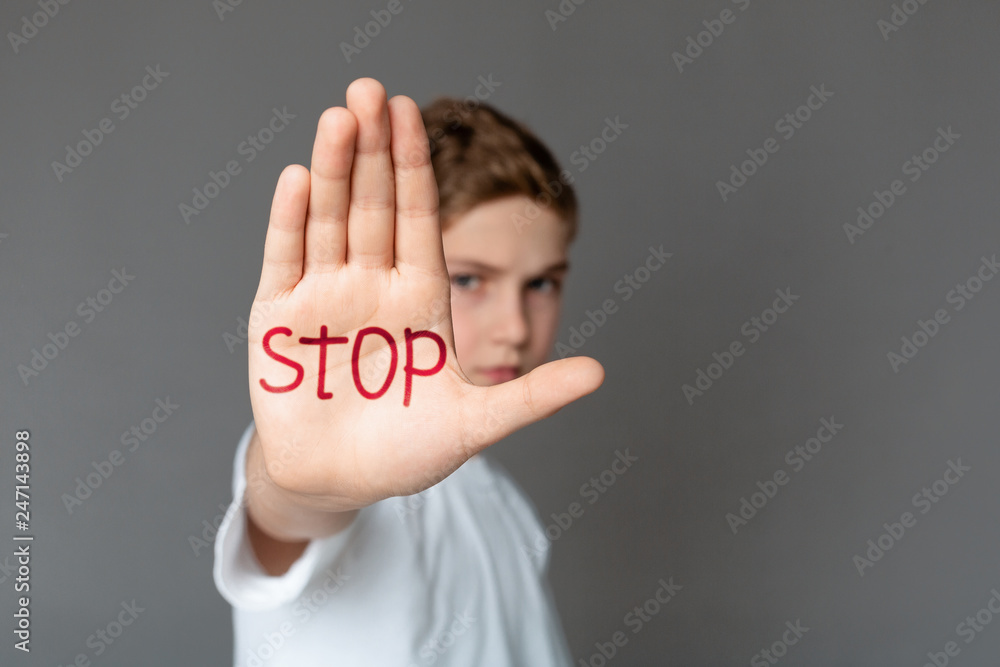 Boy showing stop gesture with his hand Stock Photo | Adobe Stock