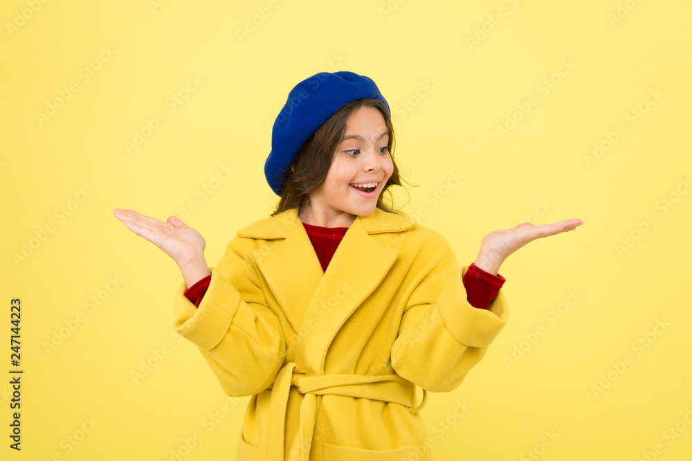 Child promoting something yellow background copy space. Place for ad ...