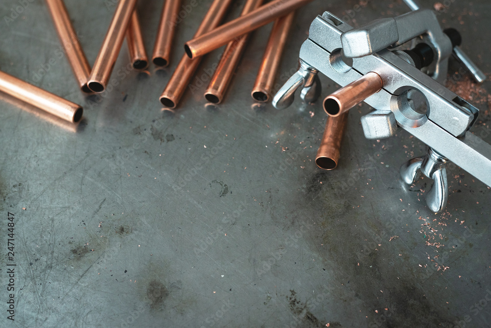 Pipe rammer tool on a fitter workbench. Pipework concept background ...