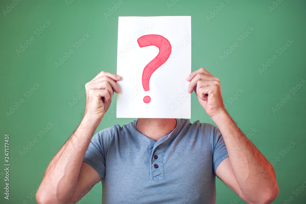 A portrait of man holding a card with question mark. People, emotions ...