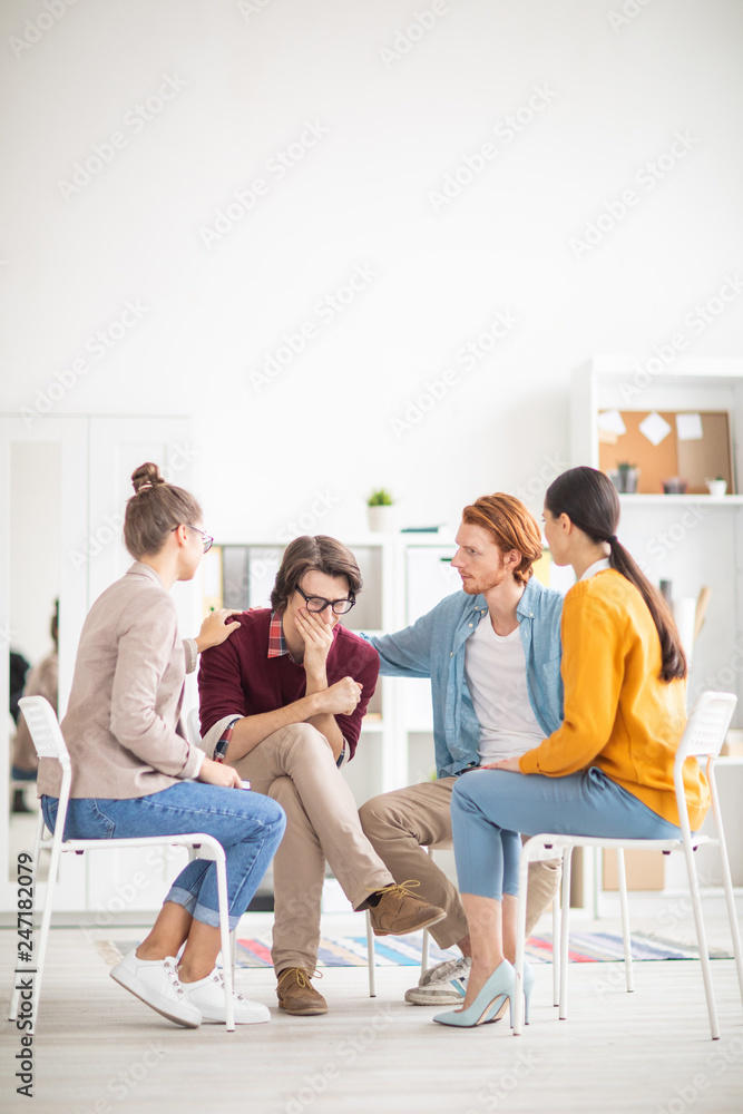 Desperate guy crying while sharing his trouble with groupmates while ...
