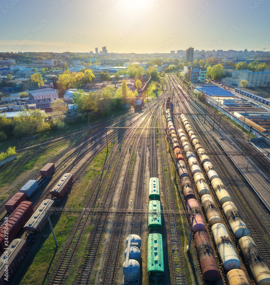 Aerial view of colorful freight trains on railway station at sunset ...