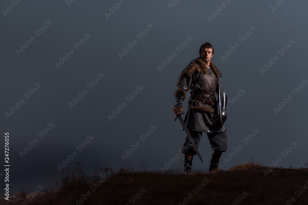 Medieval knight with sword and spear in ancient armour over Winter ...
