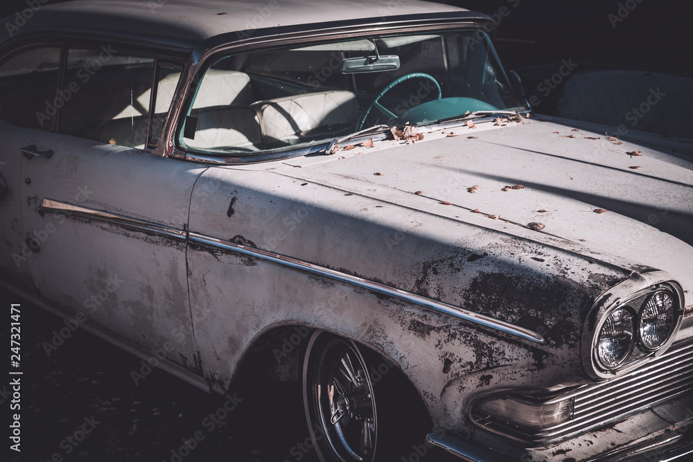 Front side view of a worn and beat up classic American car from the ...